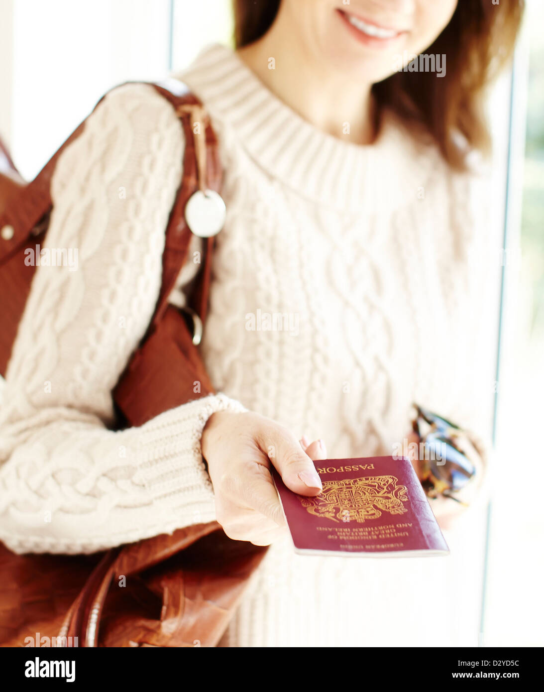 Woman showing passport Stock Photo - Alamy
