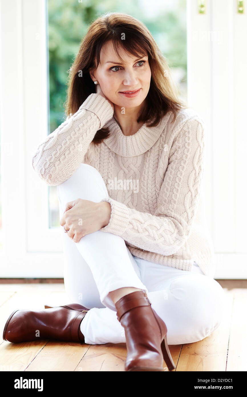Woman sat relaxing Stock Photo - Alamy