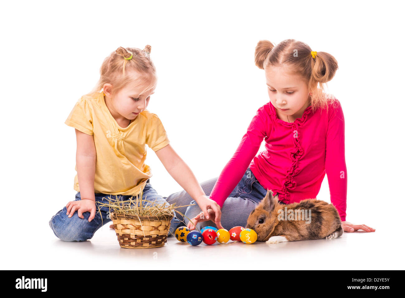 Two happy kids with easter bunny and eggs isolated on white. Happy ...