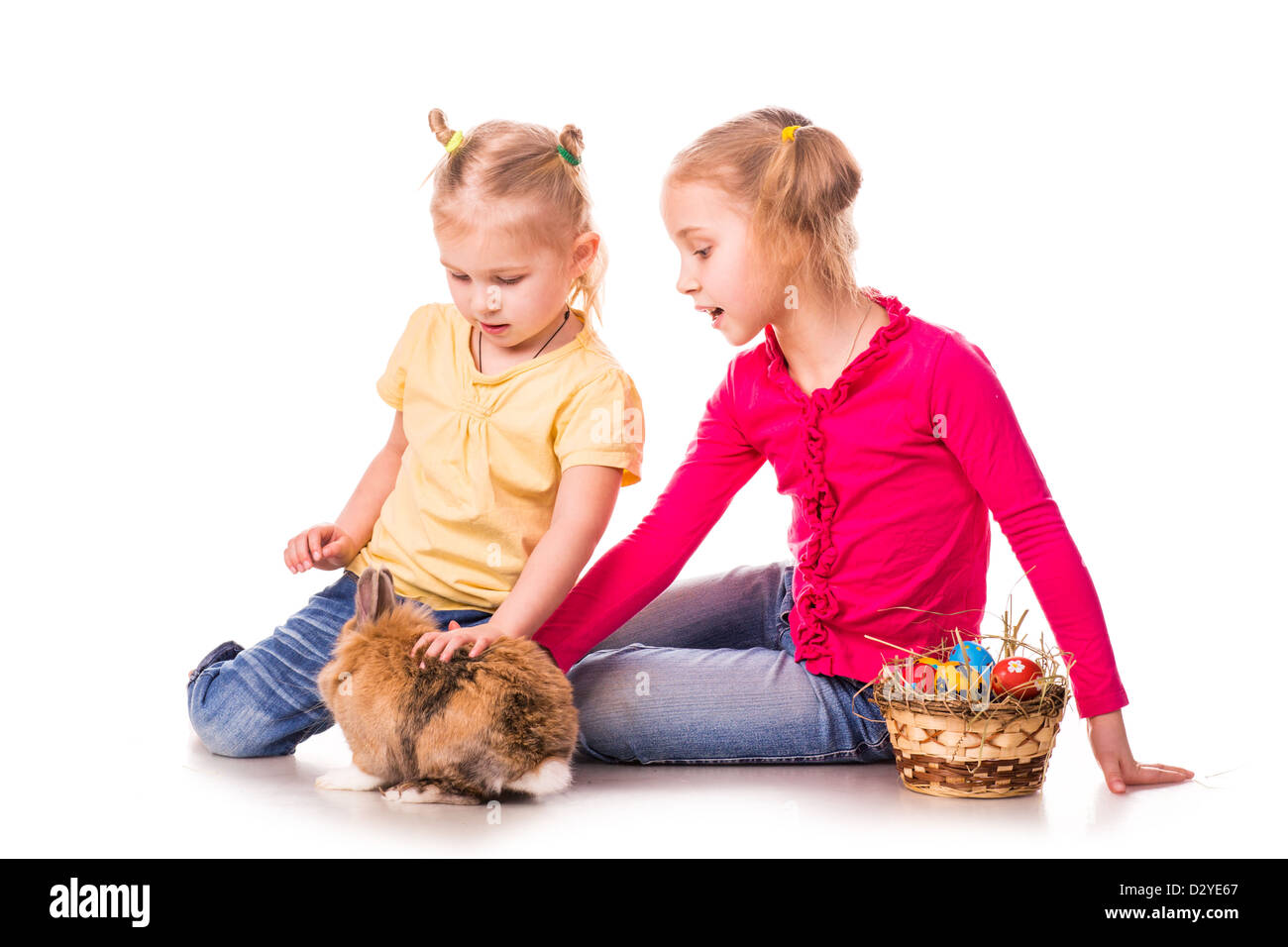 Two happy kids with easter bunny and eggs isolated on white. Happy ...