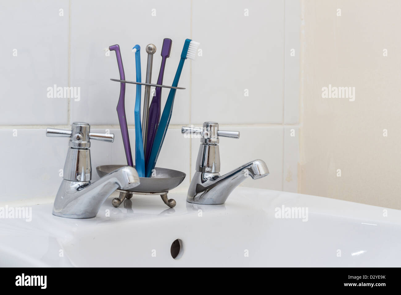Toothbrushes in bathroom Stock Photo - Alamy