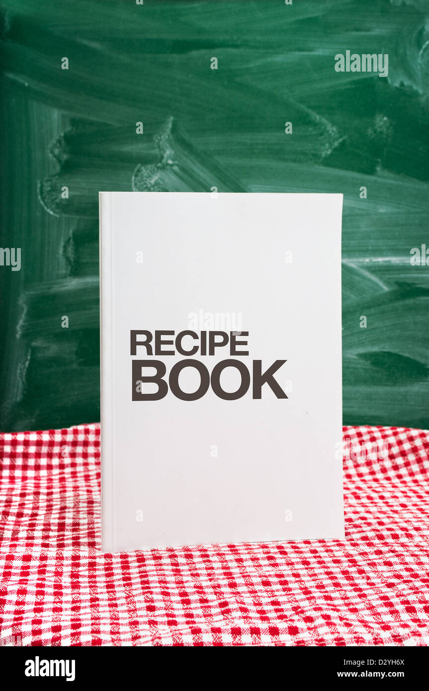 Recipe book on a kitchen table with red and white checkered table cloth ...