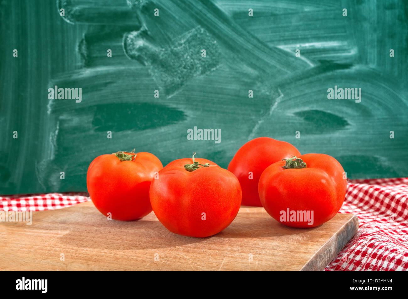 Fresh red tomato vegetable on a kitchen table Stock Photo - Alamy