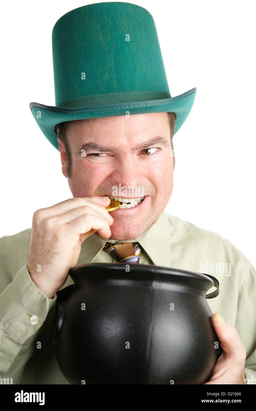 Irish man dressed as a leprechaun for St. Patrick's Day, biting a coin ...