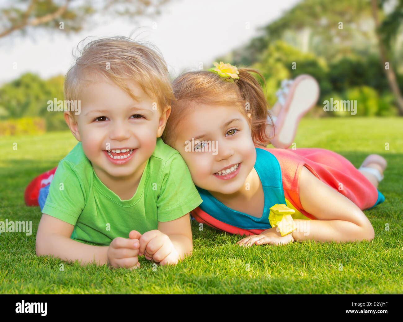 Picture of brother and sister having fun in the park, two cheerful ...