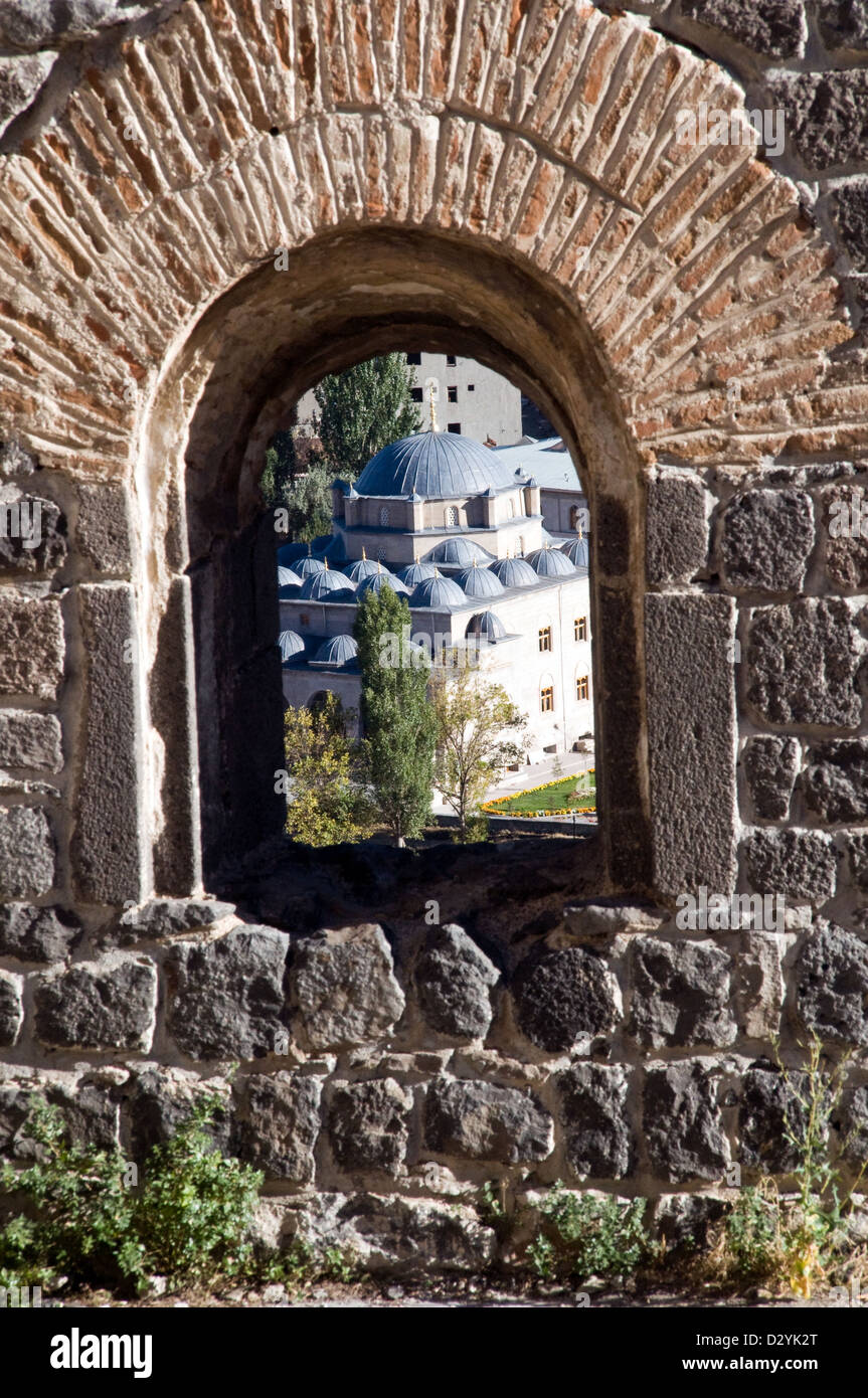 A Turkish Ottoman era mosque seen framed through a window of the ...