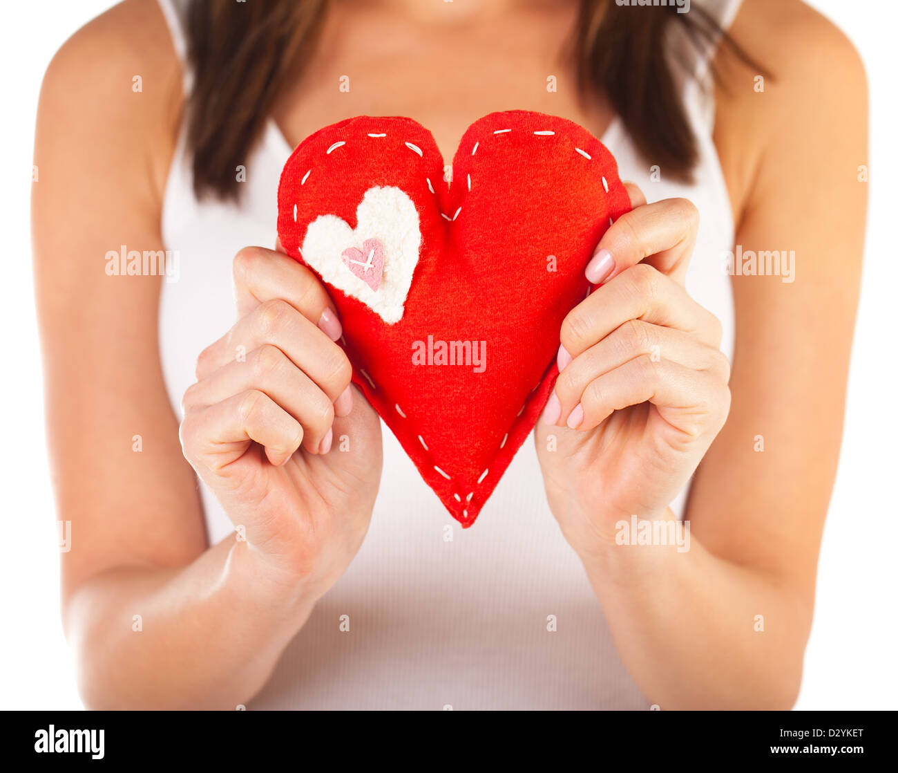Picture of brunette woman holding red soft toy heart-shaped in hands ...