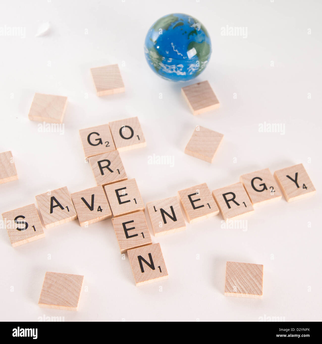 "Save Energy, Go Green" concept spelled in Scrabble letters with out of ...