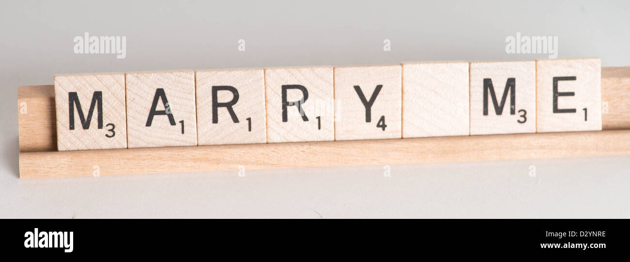 Concept: "Marry Me" Wooden Scrabble game pieces spelling out "Marry Me ...