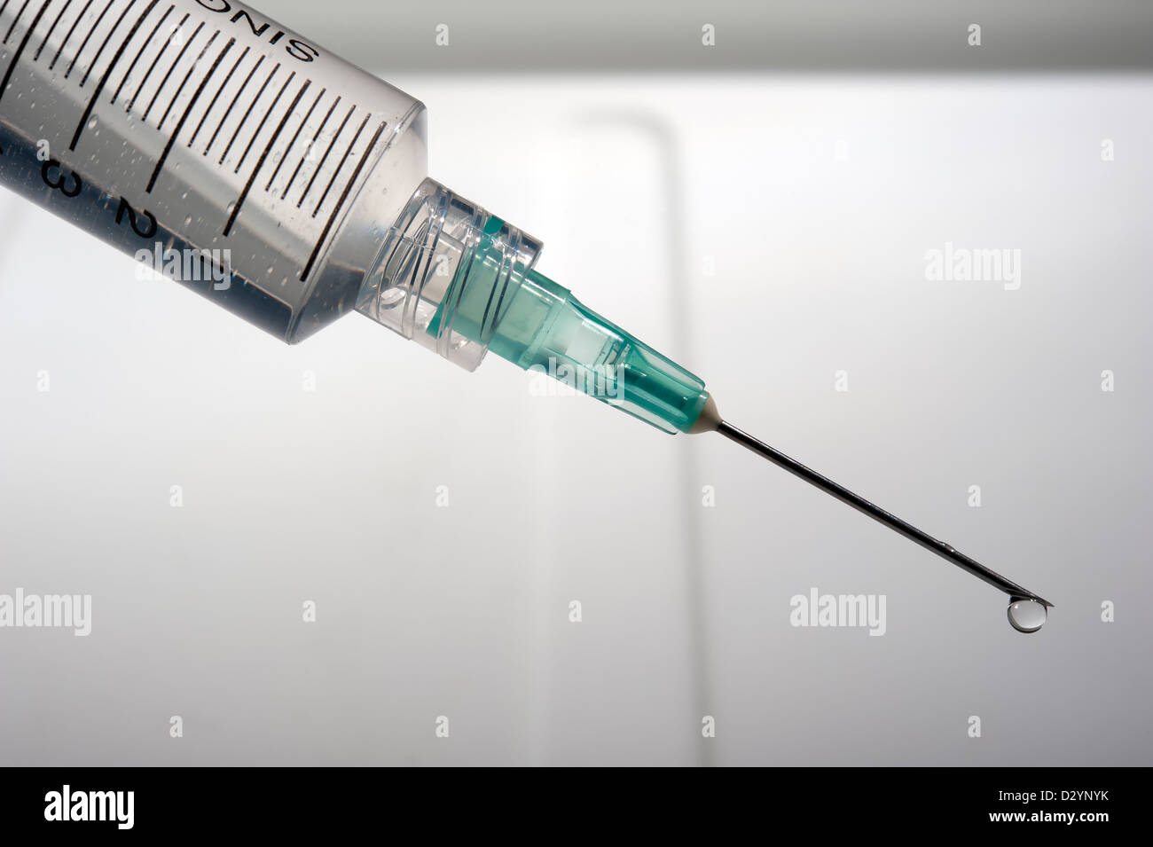 A droplet hangs from a syringe needle Stock Photo - Alamy