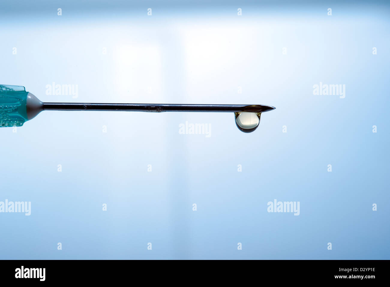 A droplet hangs from a syringe needle Stock Photo - Alamy