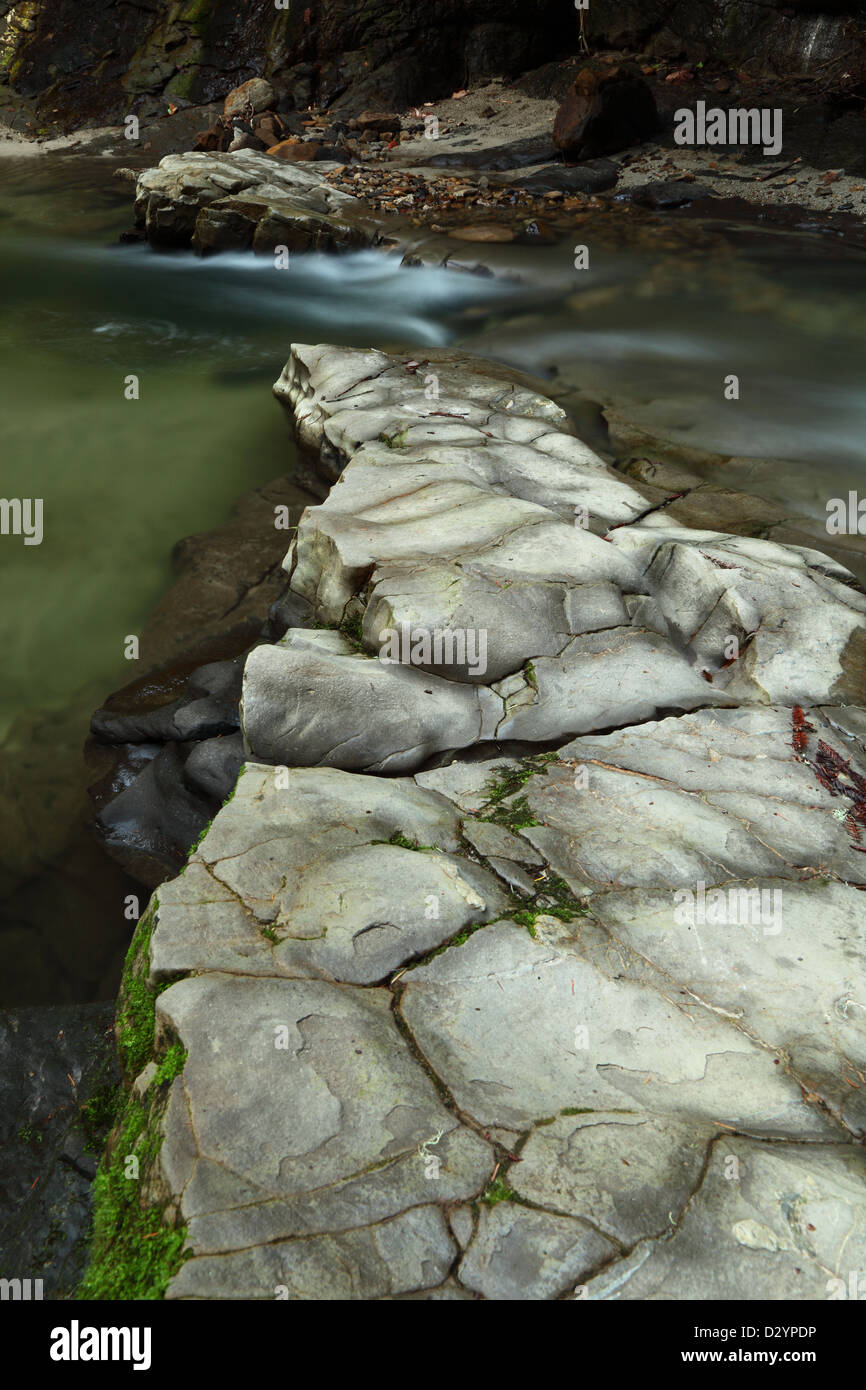 Cracked rock formation and flowing water Stock Photo - Alamy