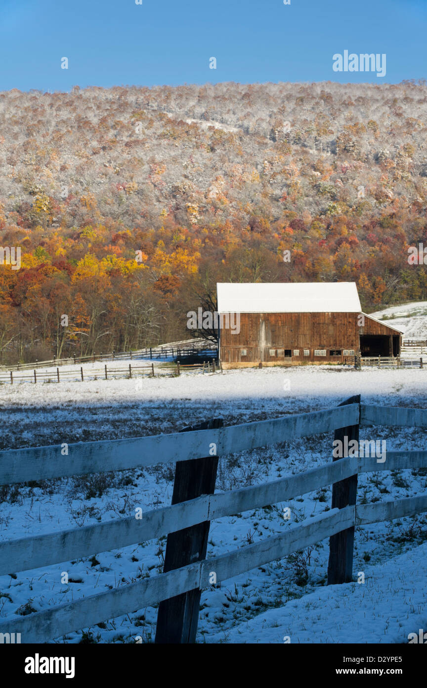 Barn and mountain in early fall snow and sunlight, a scenic cold ...
