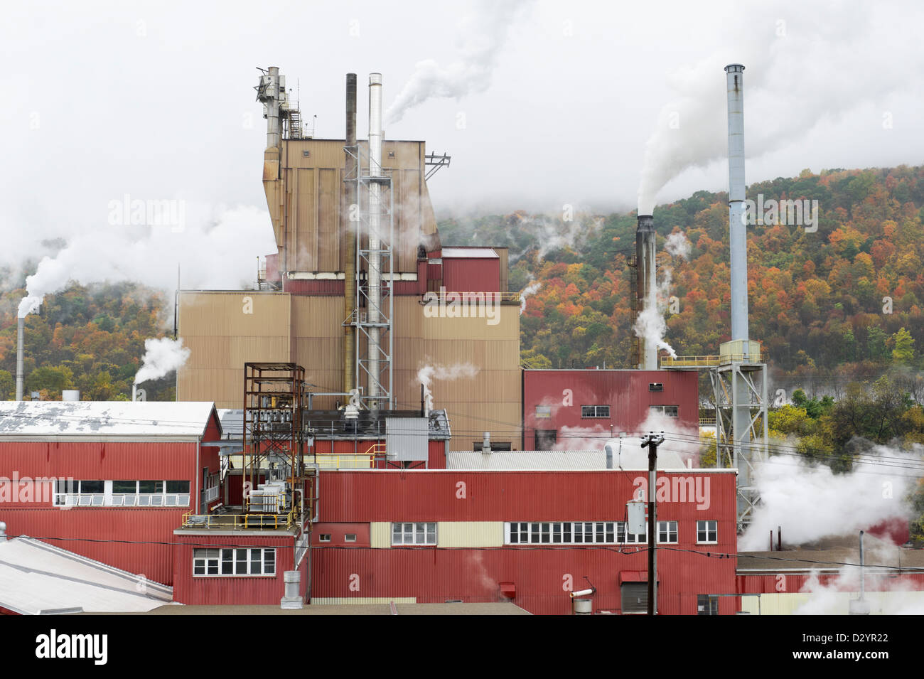 Modern factory showing steam and smoke rising, a manufacturing plant on ...