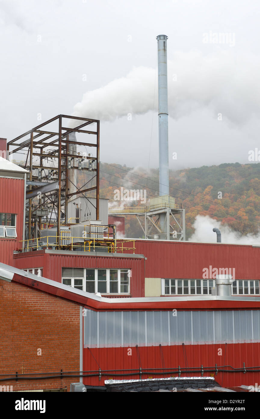 Modern factory showing steam and smoke rising, a manufacturing plant on ...
