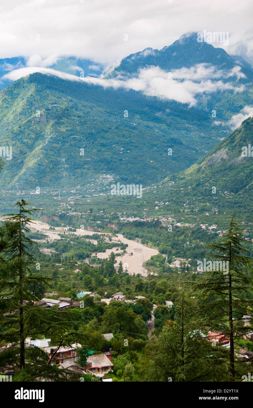 Valley with river between high mountains in clouds, North India ...