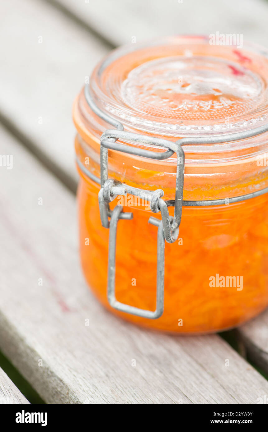 Glass container of carrot marmalade and fresh carrots Stock Photo - Alamy