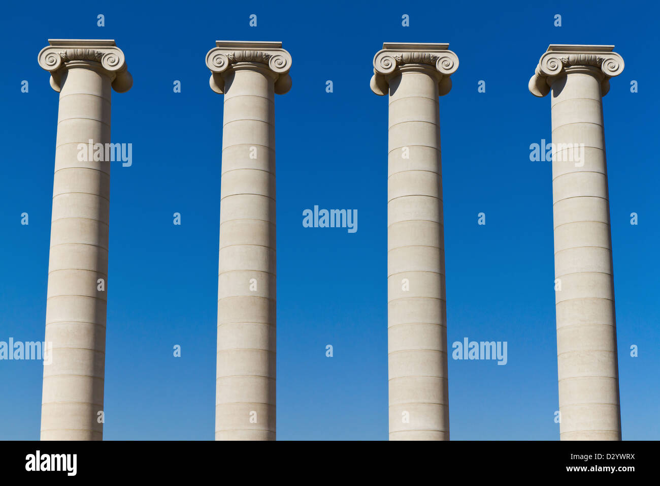 Four massive columns, blue sky Stock Photo - Alamy