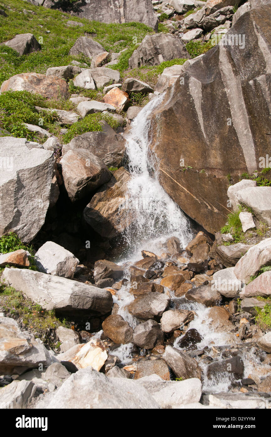 Waterfall on a mountain slope covered. Focus on the waterfall Stock ...