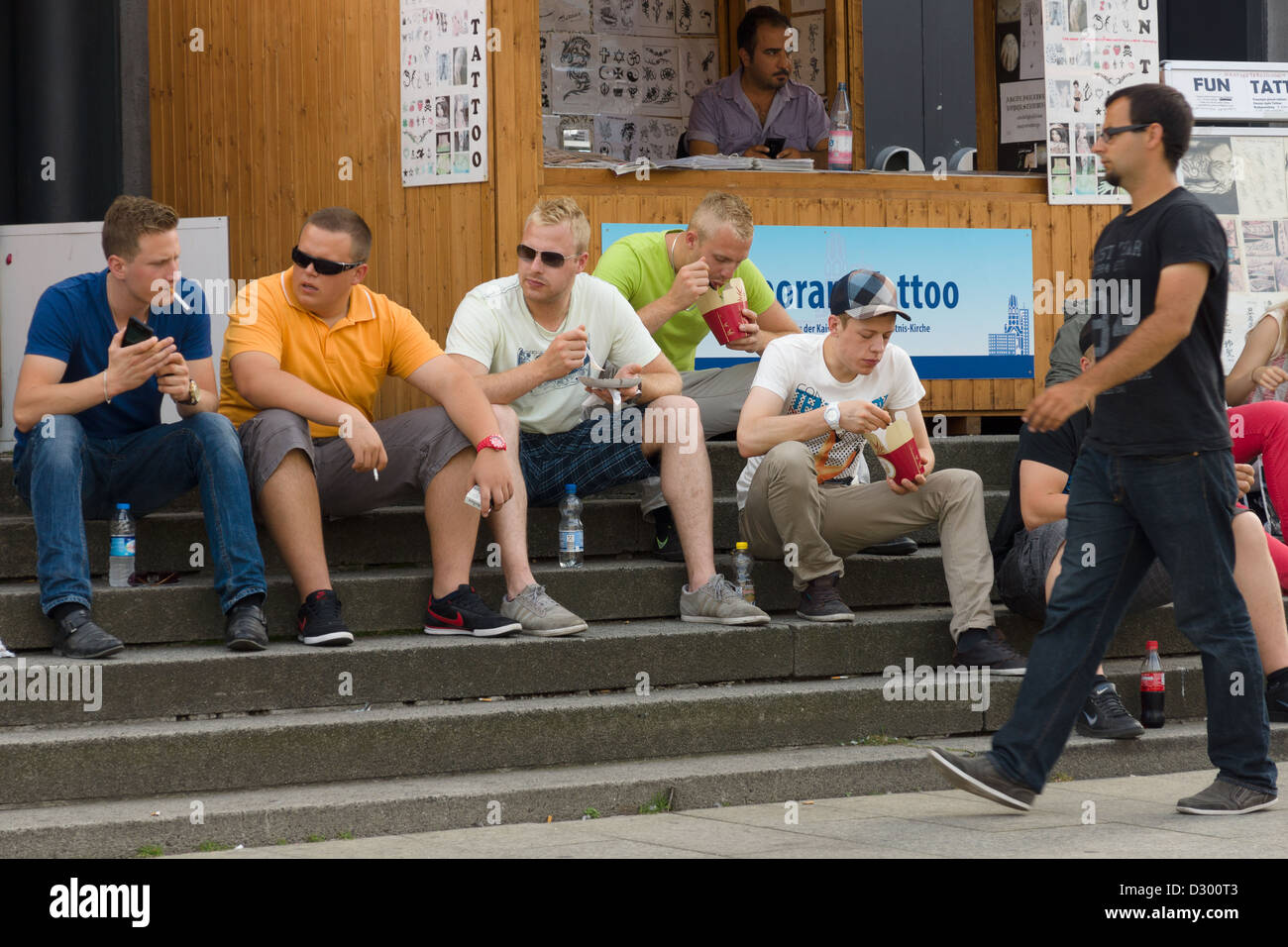 Young people sit on the steps Stock Photo - Alamy