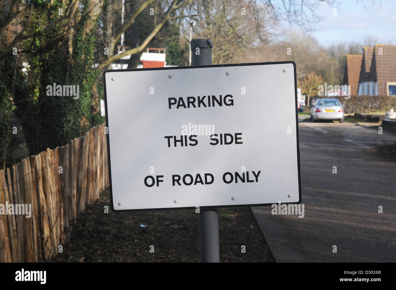 Parking this side of road only white roadsign Stock Photo - Alamy
