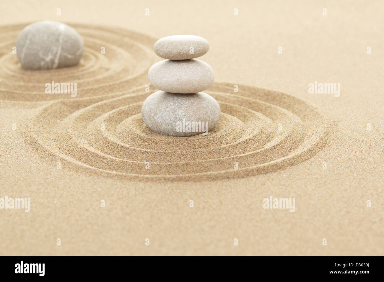 Balance of three zen stones in sand with shallow focus Stock Photo - Alamy