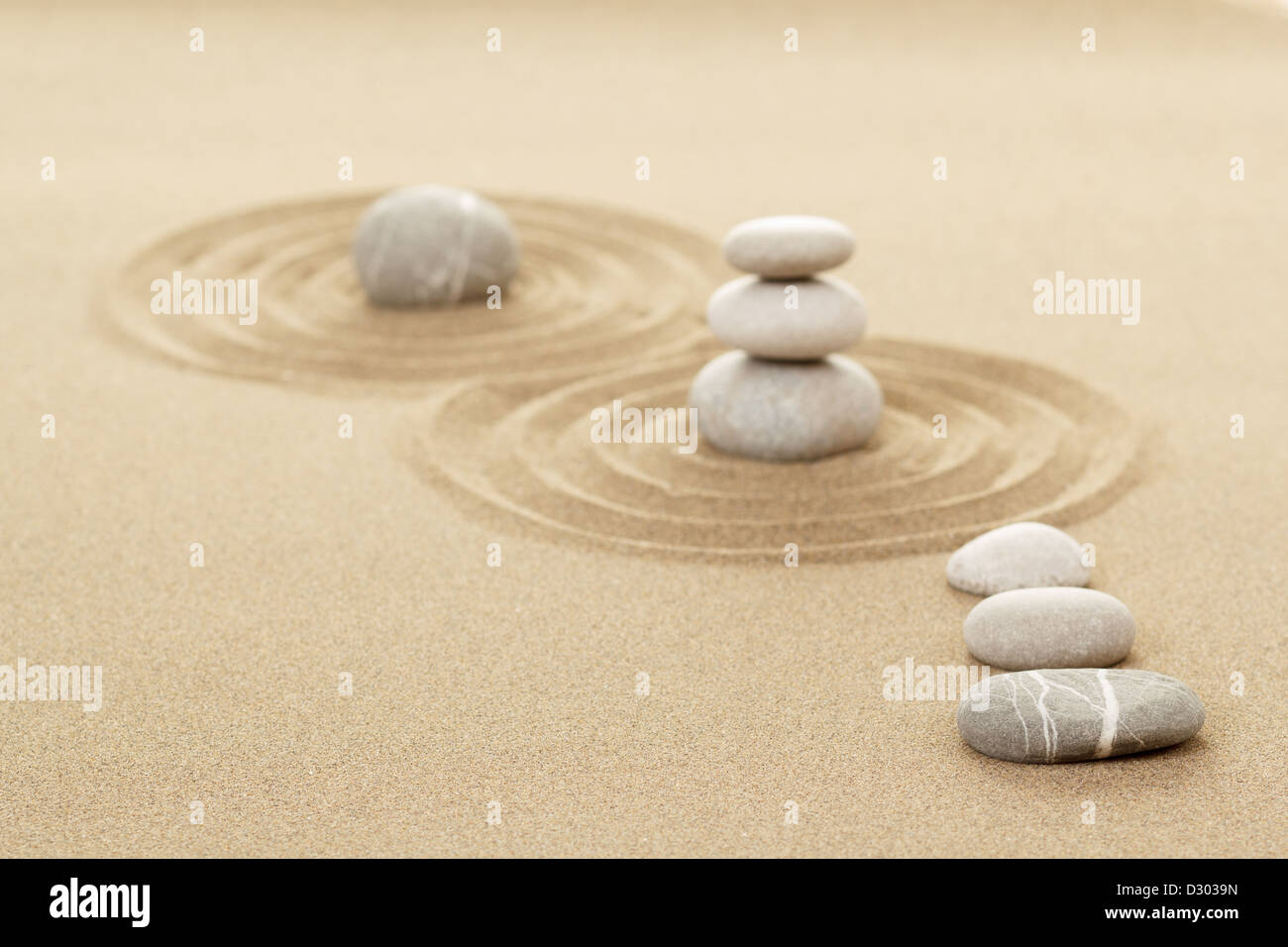 Balance of three zen stones in sand with shallow focus Stock Photo - Alamy