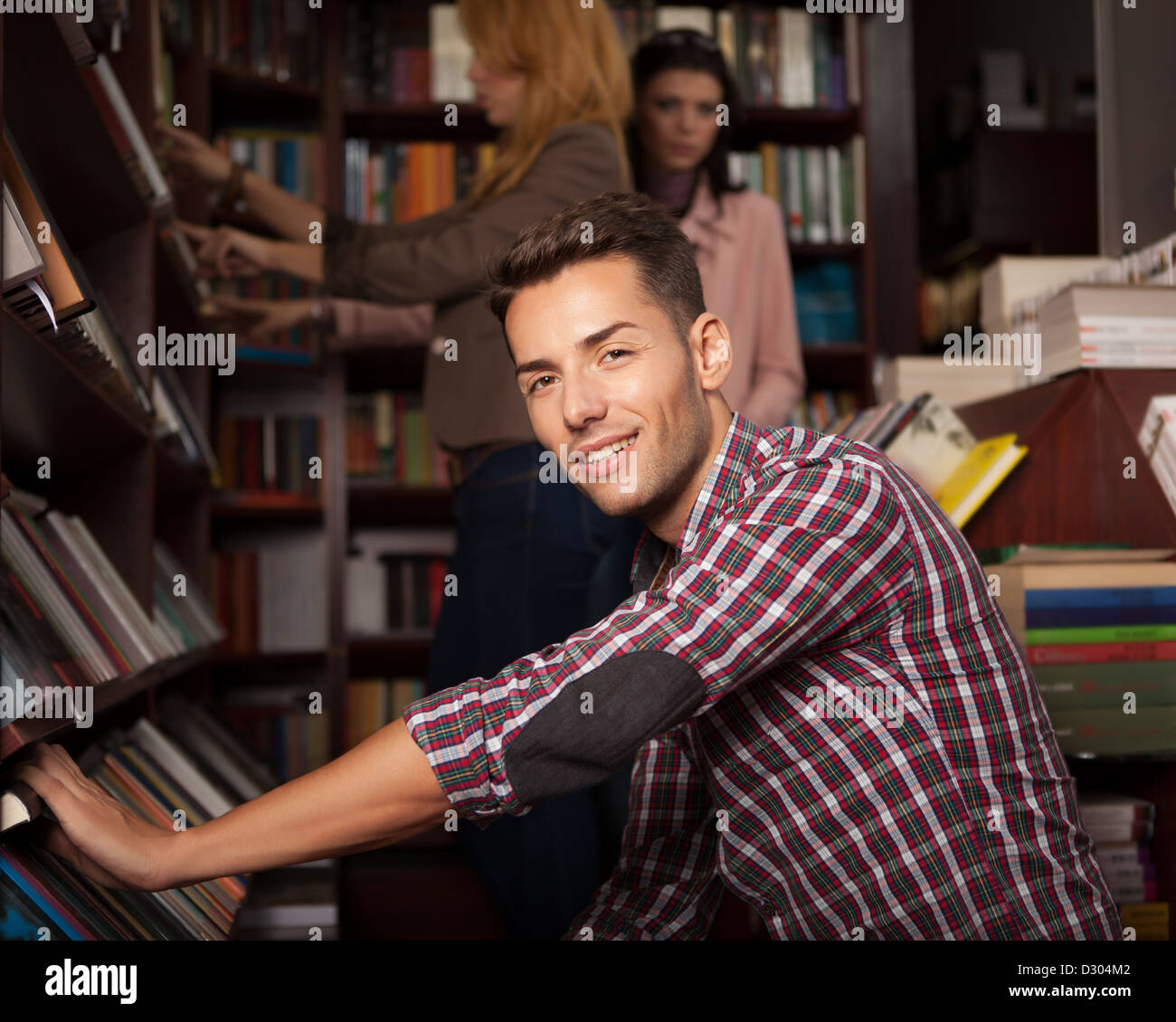 Boy choosing book from library hi-res stock photography and images - Alamy