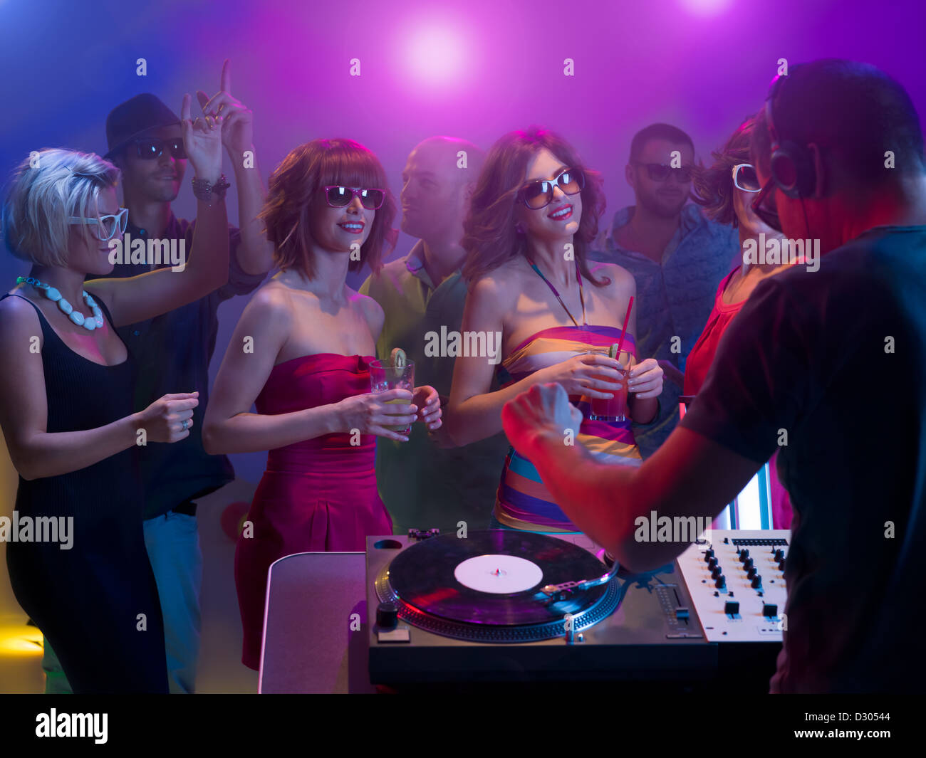 dj playing music with vinyl records, turntables and headphones in front ...