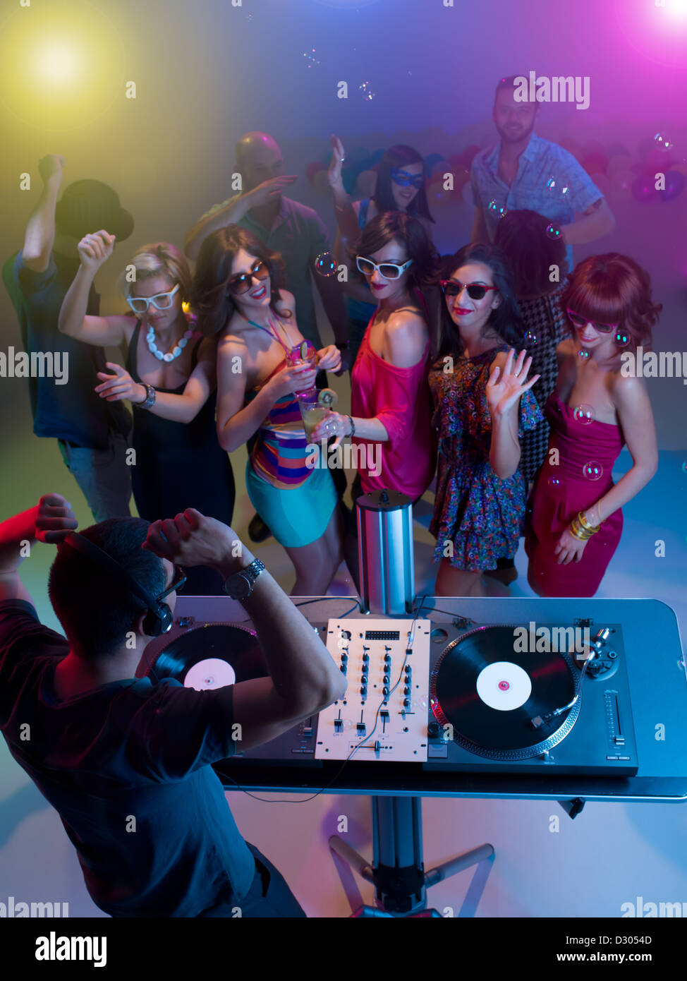 upper view of dj standing and playing music with turntables at a party ...