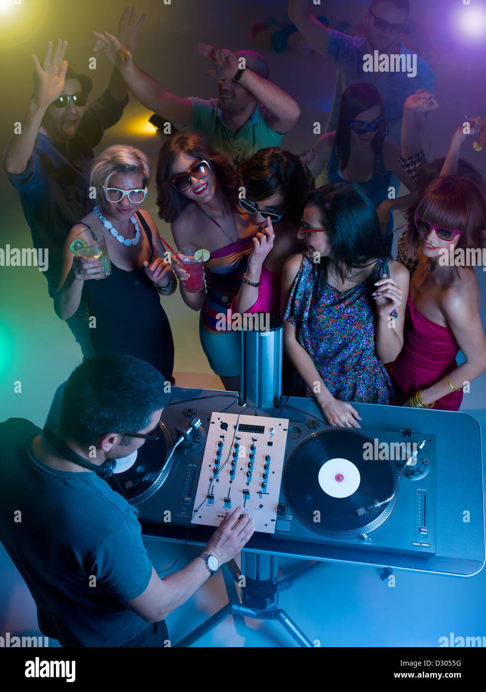 upper view of dj standing and playing music with turntables at a party ...