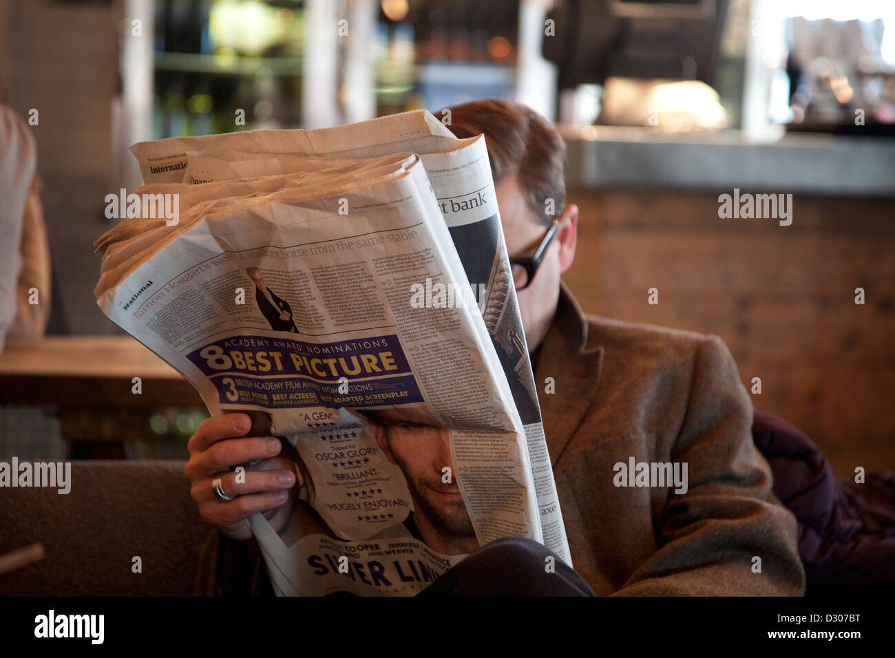 A man reading the Guardian newspaper Stock Photo - Alamy