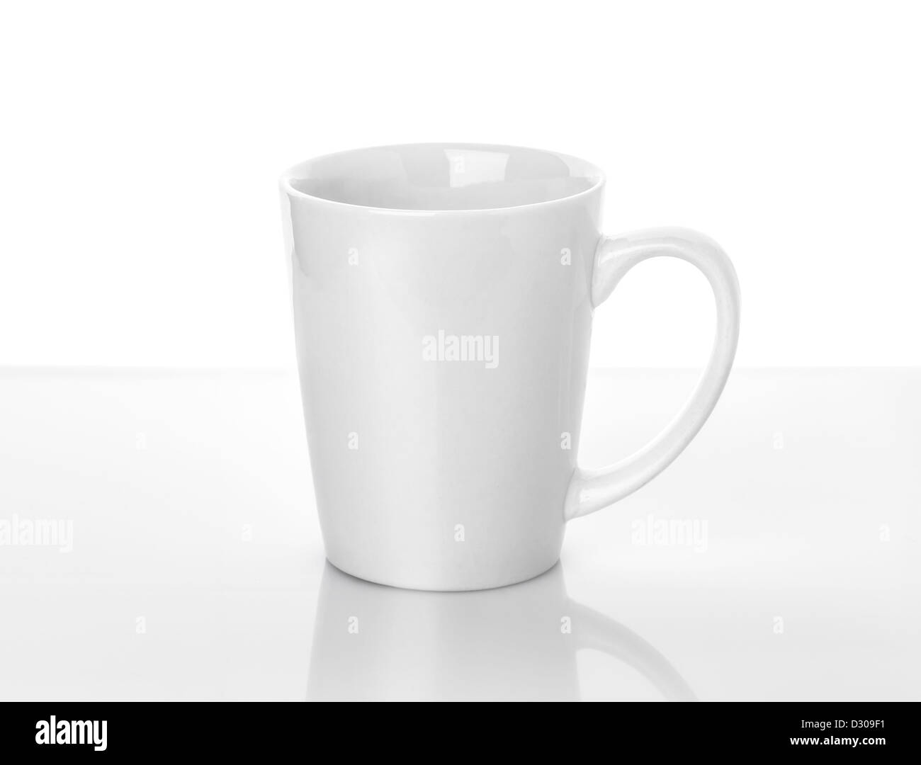 White ceramic cup stands on table above white background Stock Photo ...