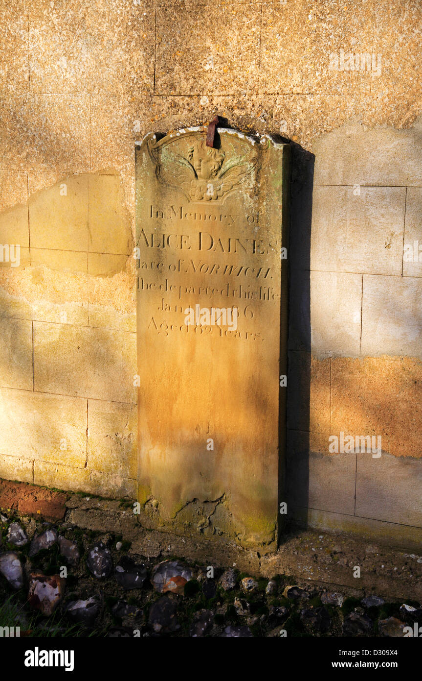 An old headstone on the east wall of the church of St Remigius at ...