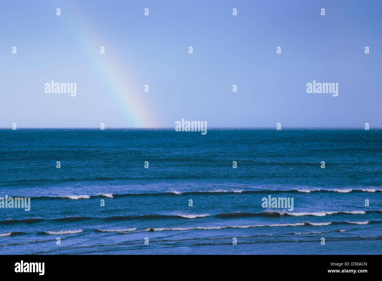 Rainbow going into the sea Stock Photo - Alamy