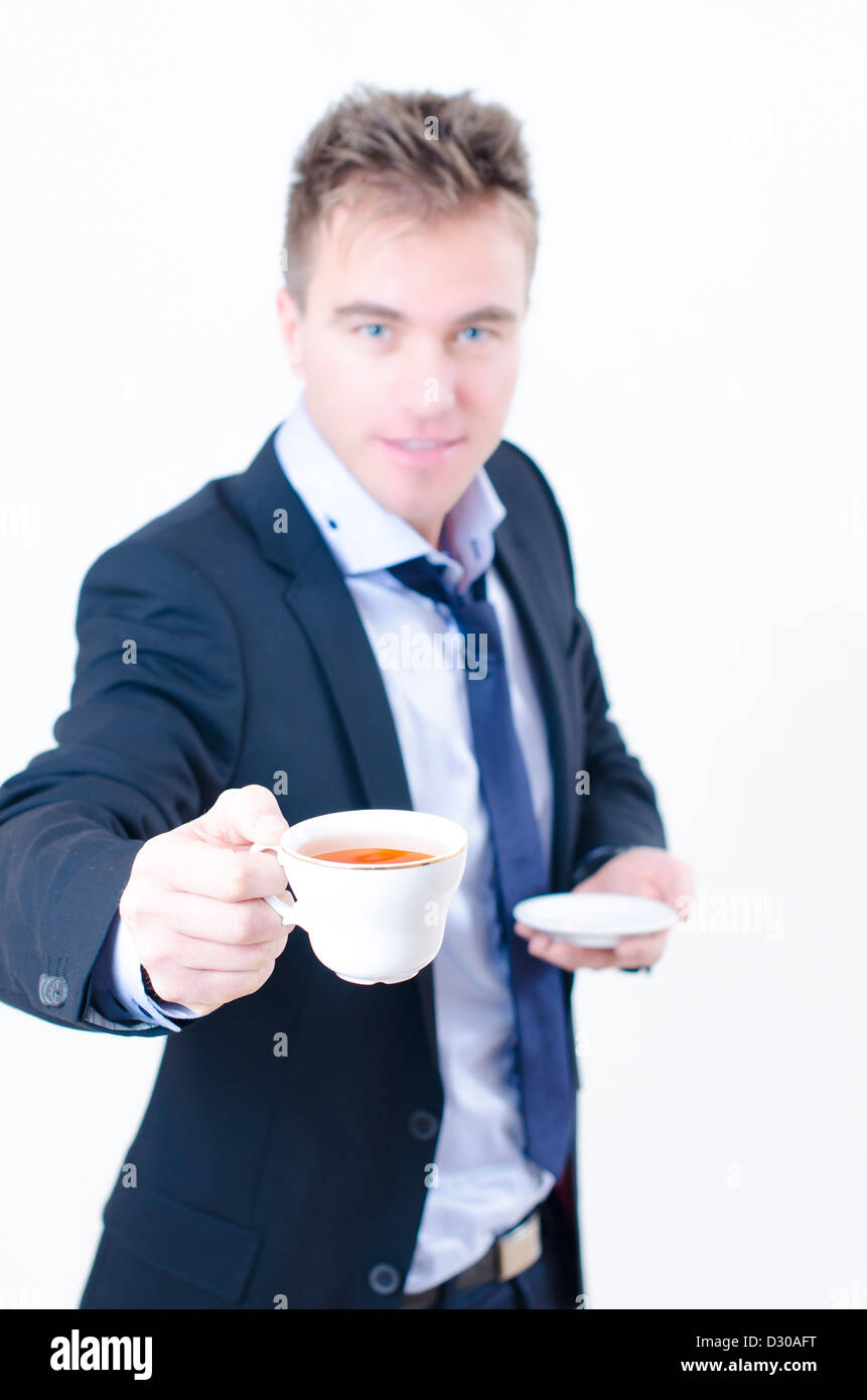 A hospitable man holding a cup of beverage Stock Photo - Alamy