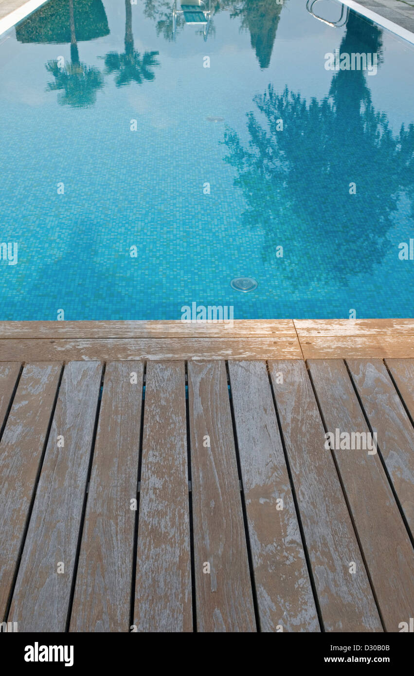 timber decking by the side of a swimming pool Stock Photo - Alamy