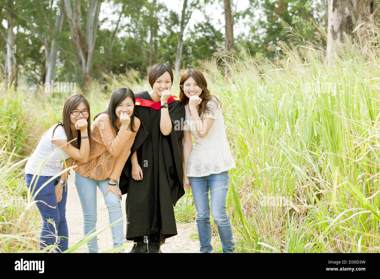 Asian friends in graduation Stock Photo - Alamy