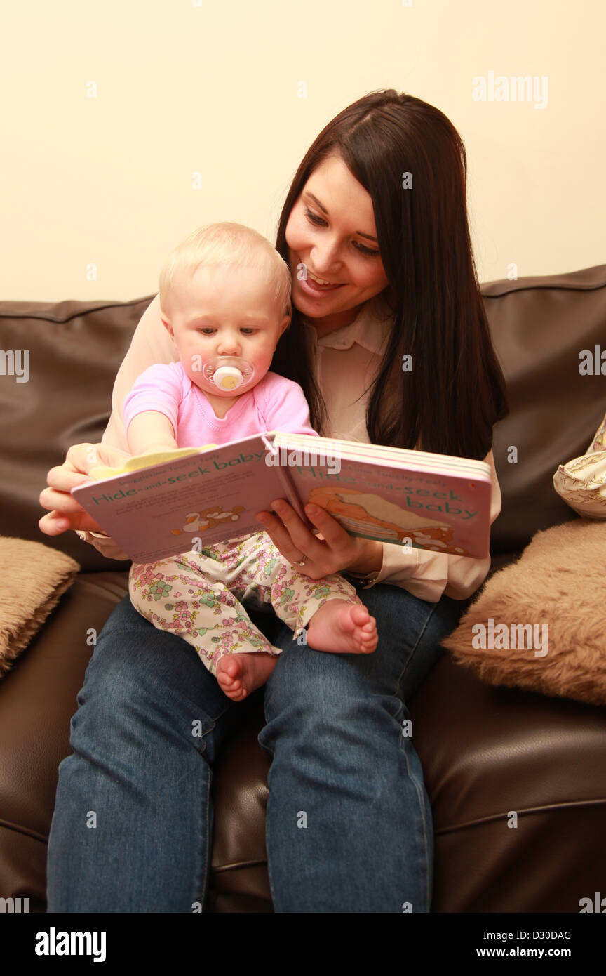 Mother reading to her baby daughter Stock Photo - Alamy