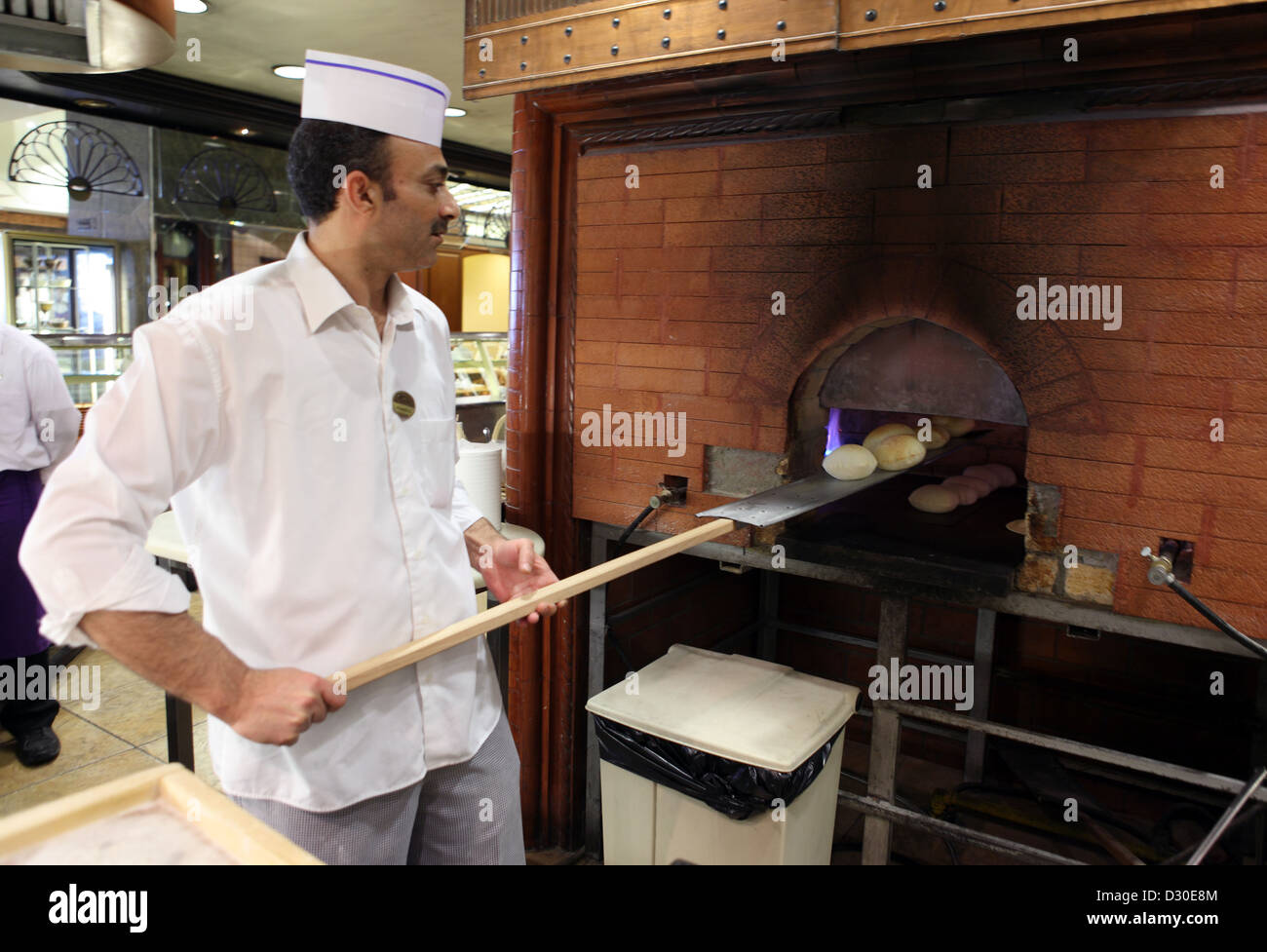 Dubai, United Arab Emirates, baker brings fresh buns from a furnace ...