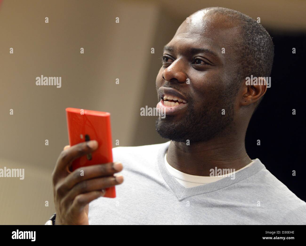 Soccer player Hans Sarpei looks at his smartphone at the Berlin ...