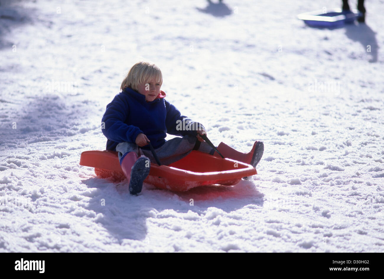 Young Girl Sledging in the snow Stock Photo - Alamy