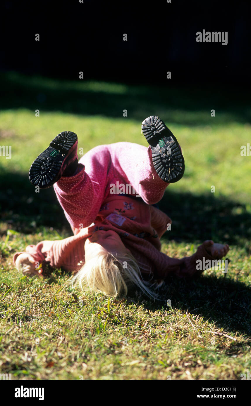 Children, young girl about 5 years old playing tumble in garden Stock ...