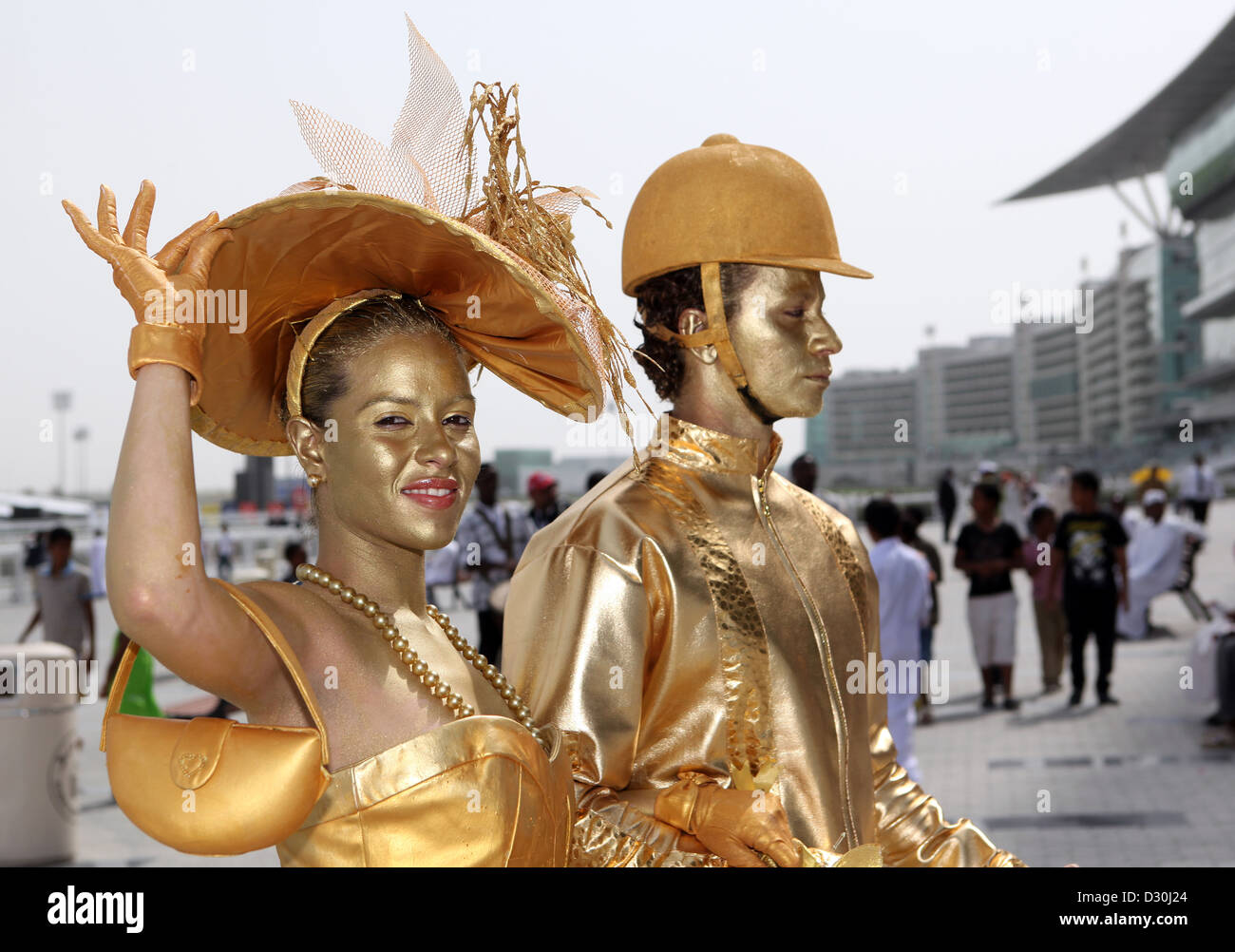 Dubai, United Arab Emirates, women and men dressed in gold at the races ...