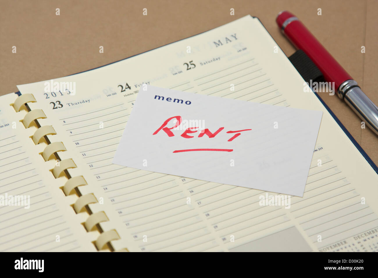 Diary with handwritten reminder to pay rent Stock Photo - Alamy
