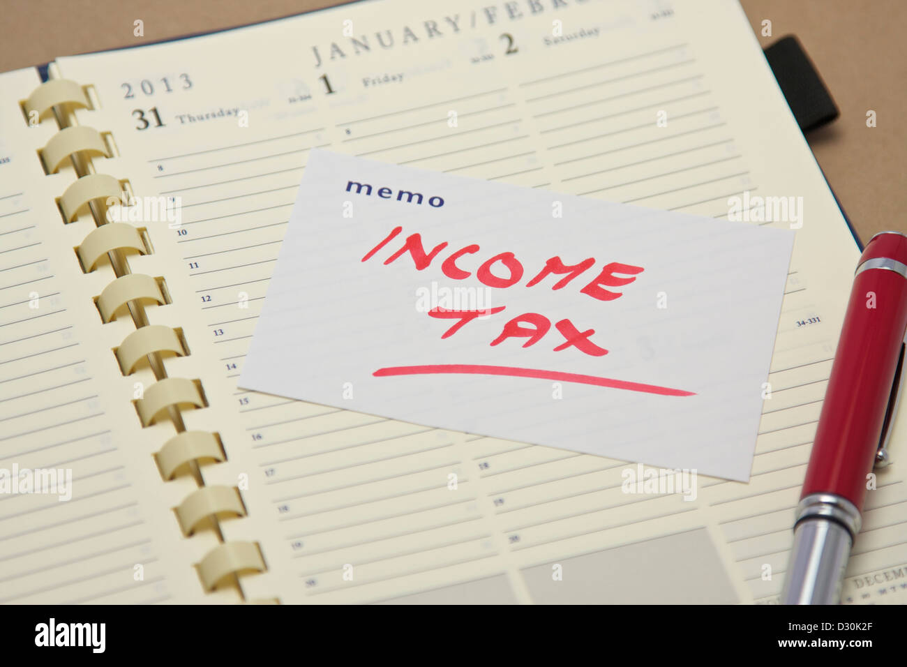 Open diary with handwritten note to pay income tax Stock Photo - Alamy
