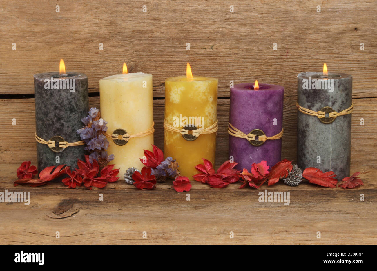 Five burning Feng Shui candles and potpourri on a background of old ...