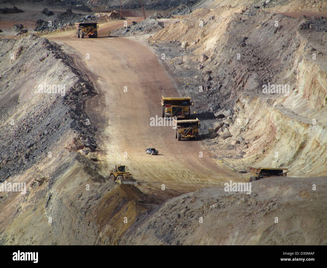 Huge trucks in the biggest Canadian open pit iron mine in Fort Wright ...