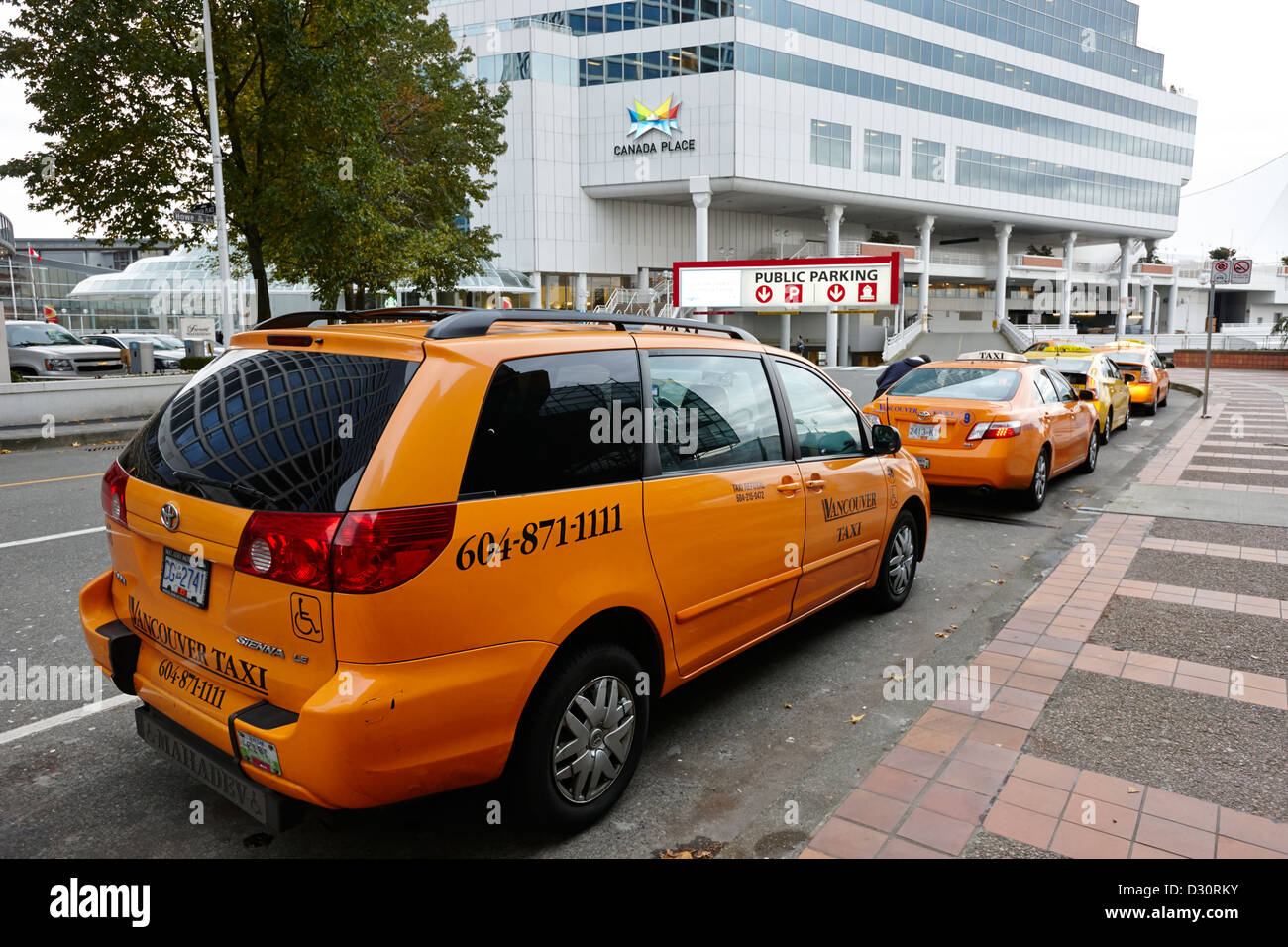 row of yellow cabs outside canada place Vancouver BC Canada Stock Photo ...
