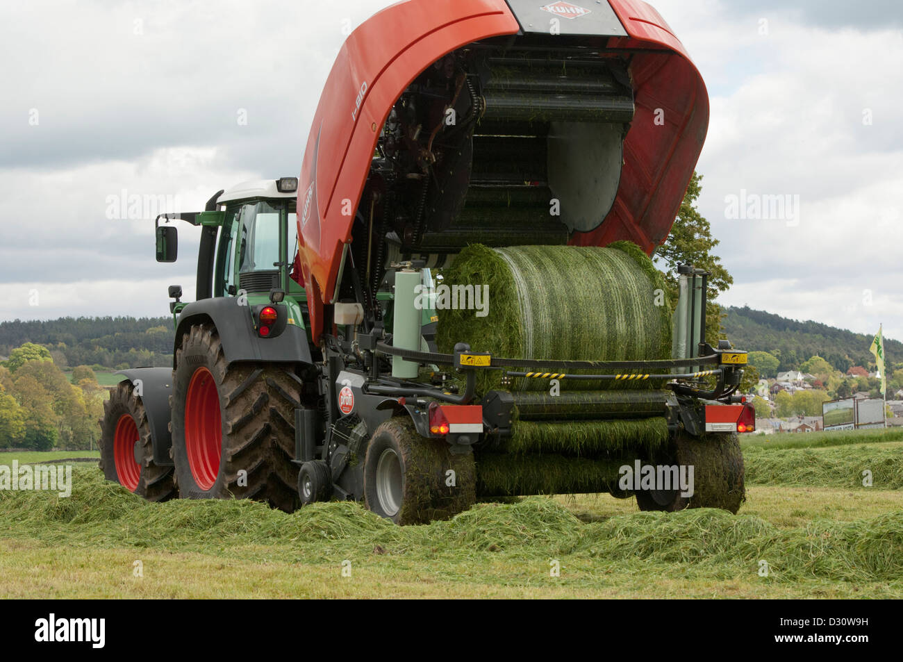 Kuhn all in one baler and wrapper at work in silage field Stock Photo ...